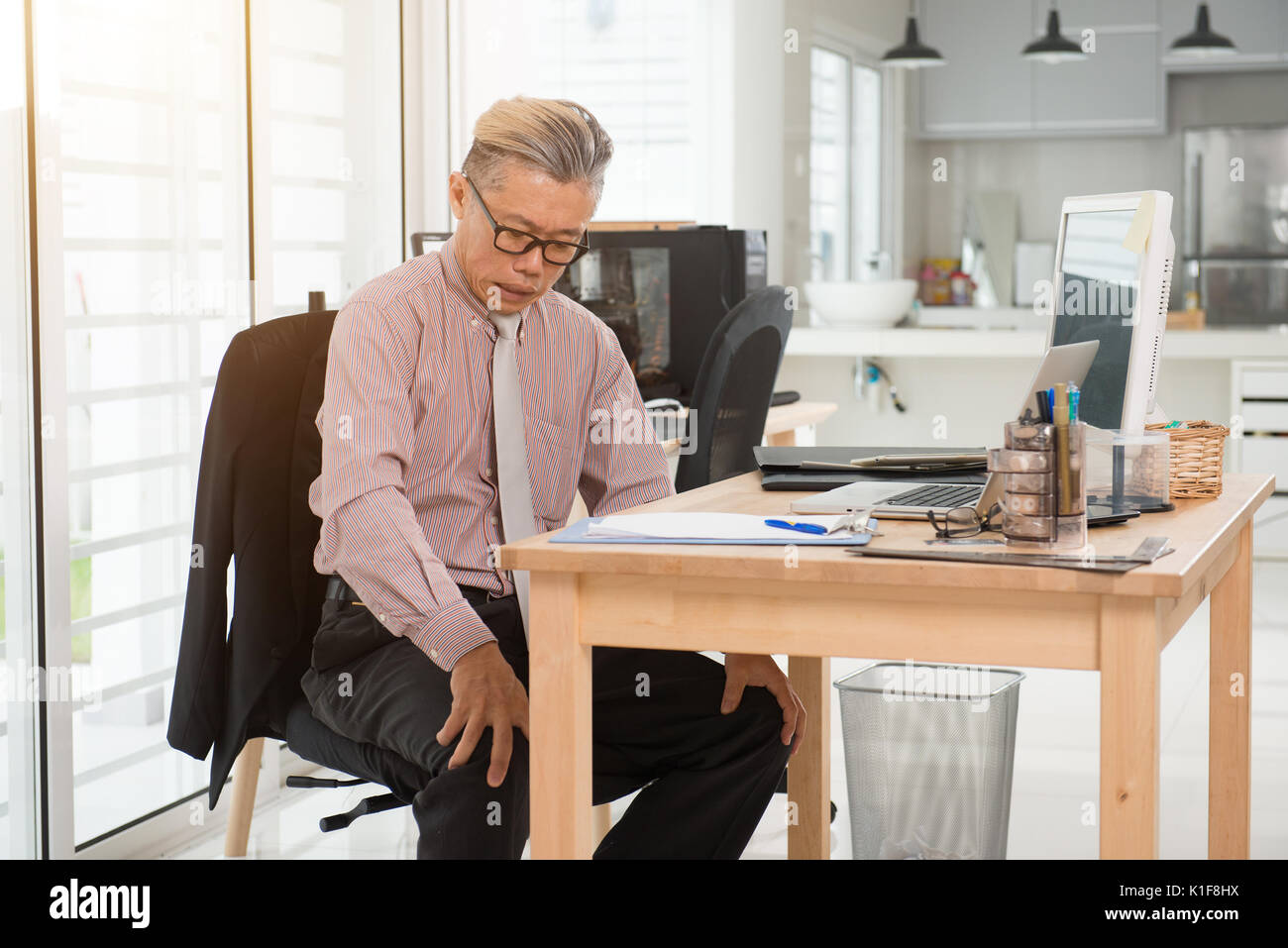 asian senior business man sick at work Stock Photo - Alamy