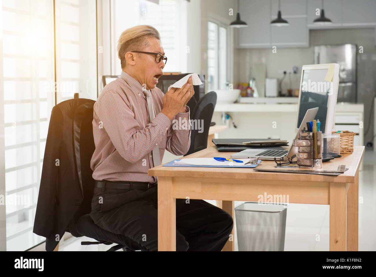 asian senior business man flue at work Stock Photo - Alamy