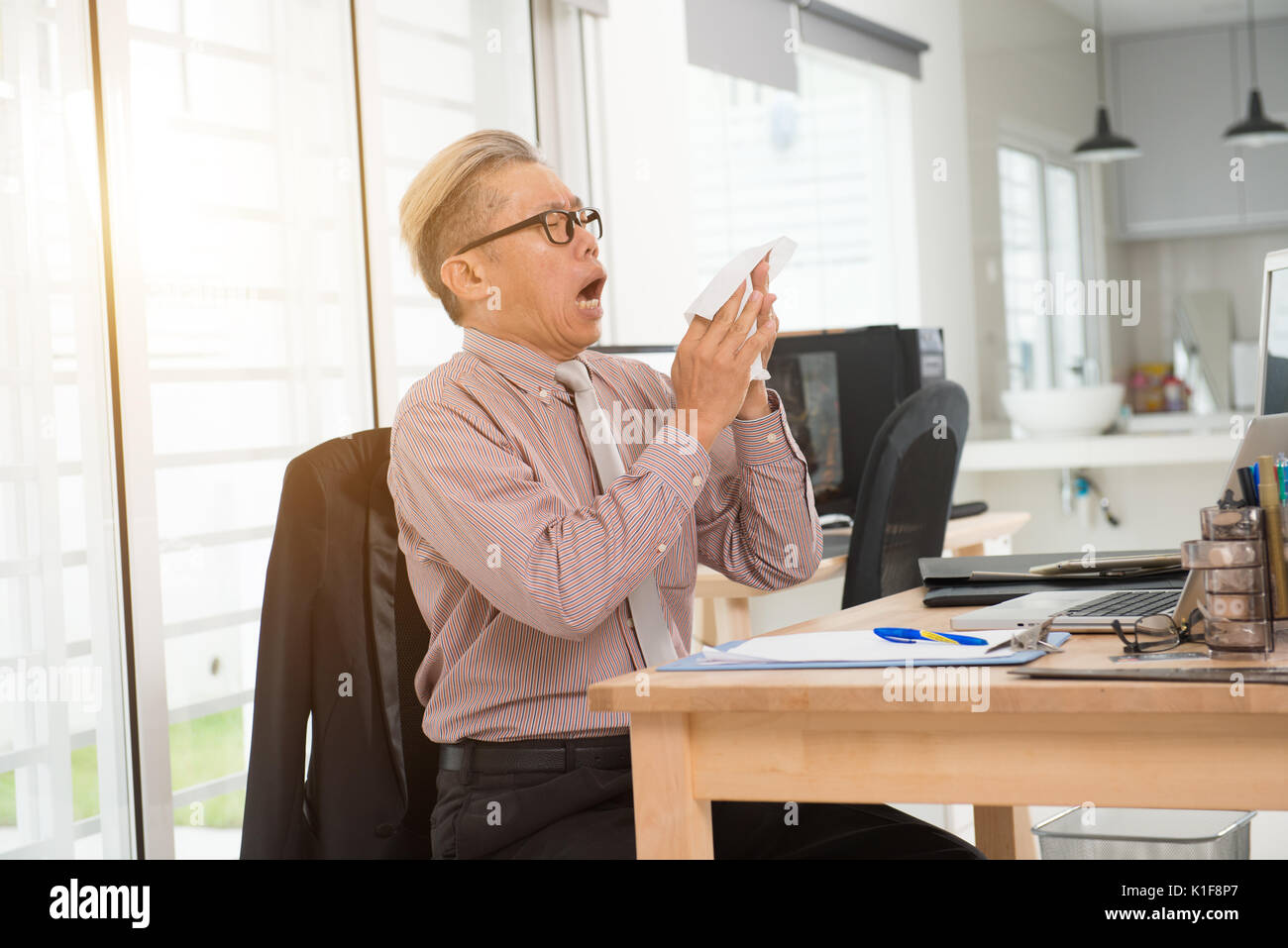 asian senior business man flue at work Stock Photo - Alamy