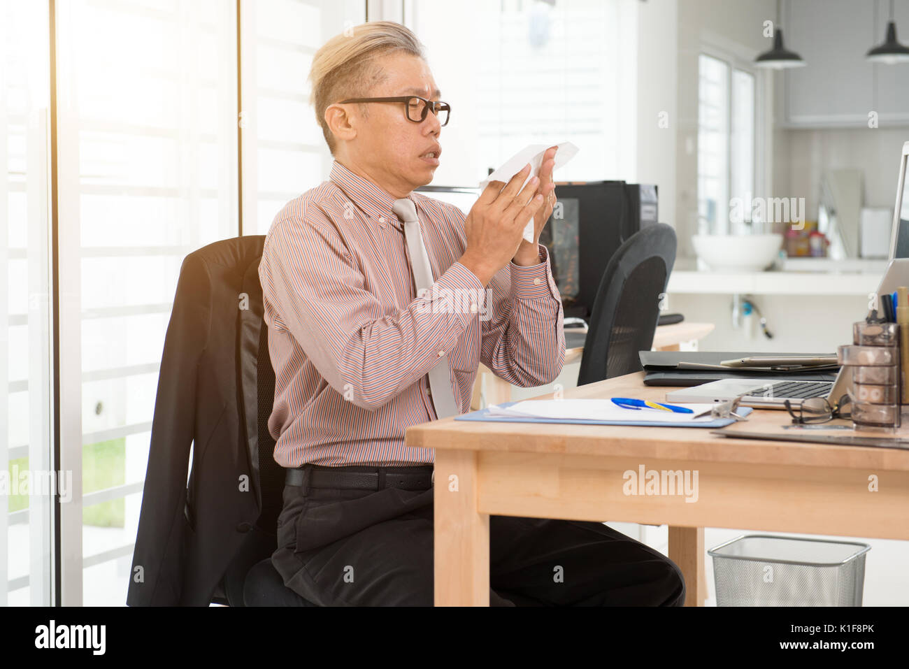 asian senior business man flue at work Stock Photo - Alamy