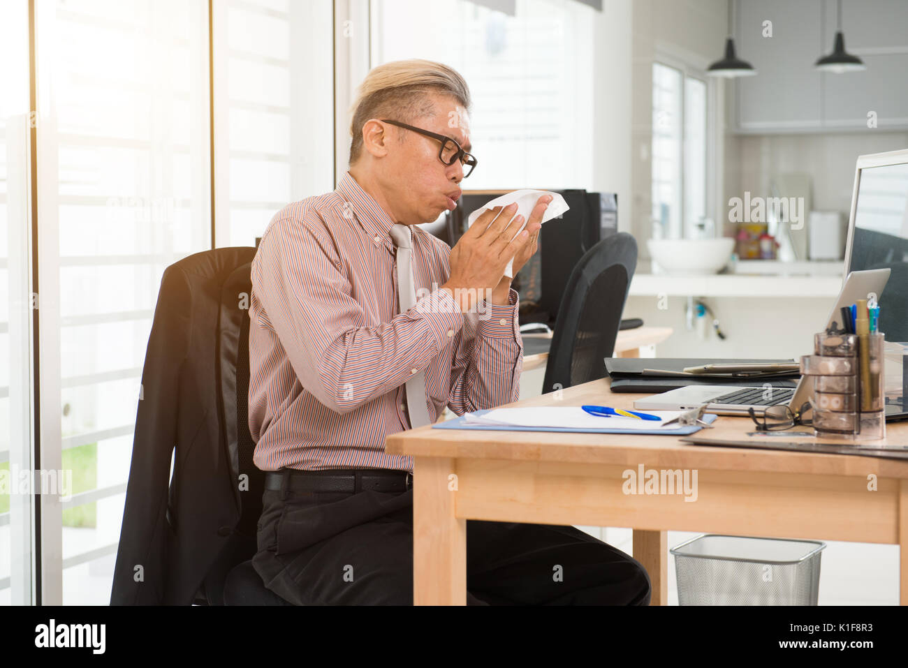 asian senior business man flue at work Stock Photo - Alamy