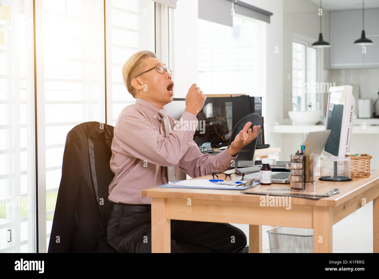 asian senior business man taking medicine at work Stock Photo - Alamy