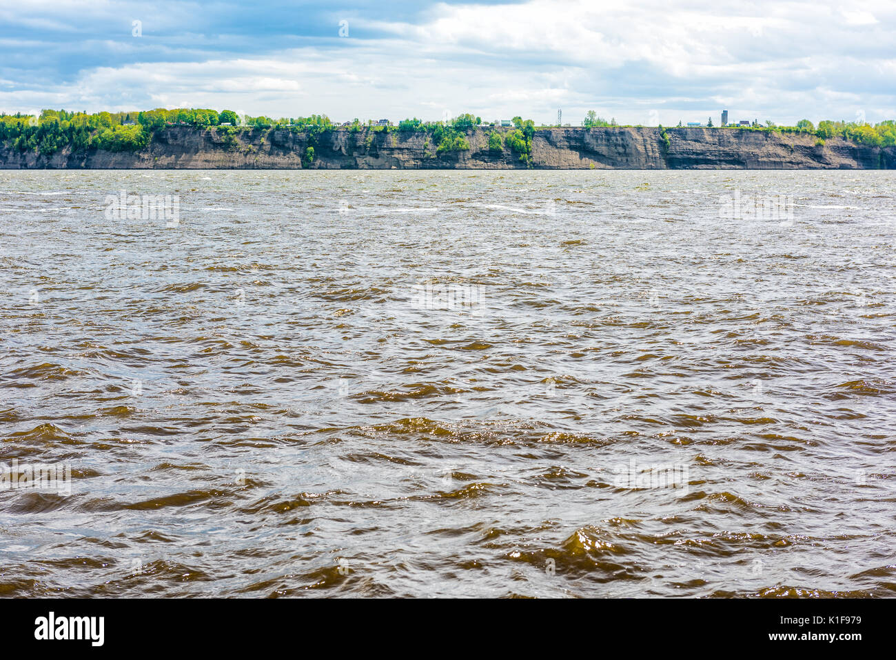 Cityscape or skyline of Sainte-Croix and view of cliffs by brown water ...