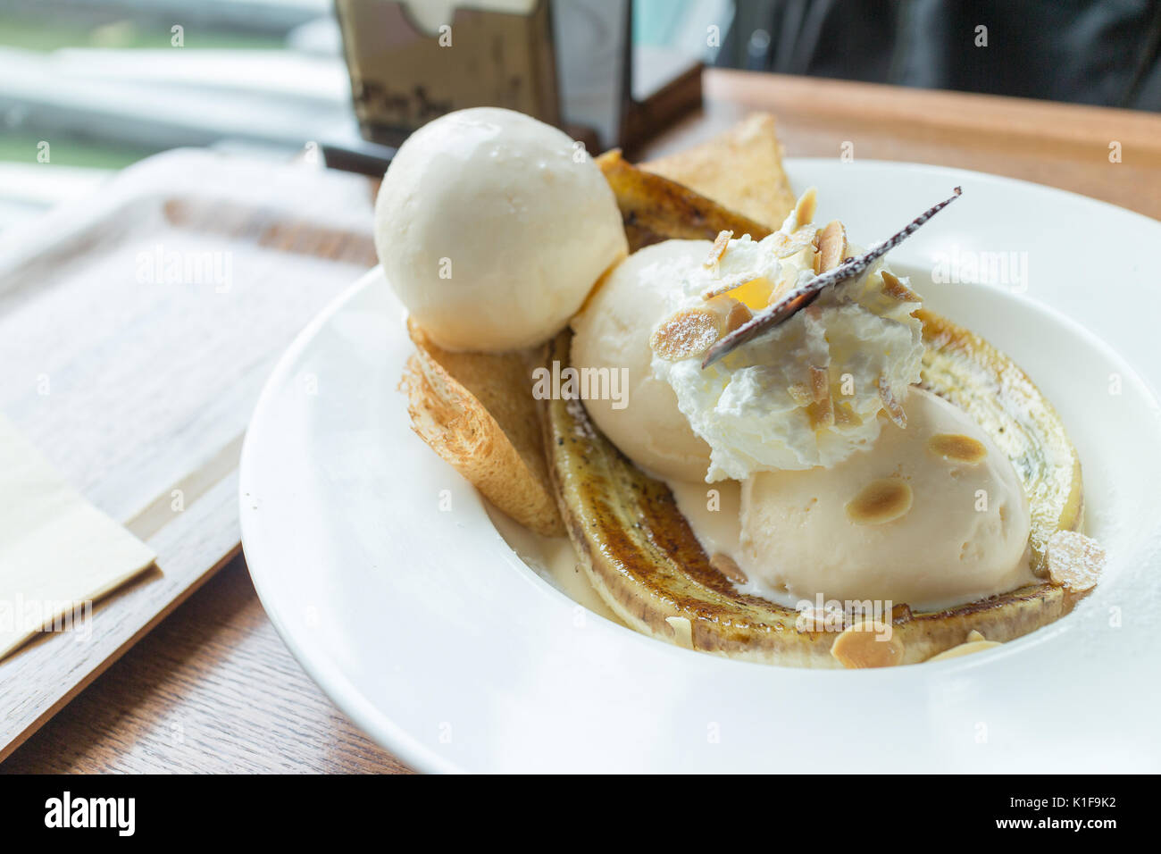 Crepe with ice cream and banana burned topping. A crepe is a type of ...