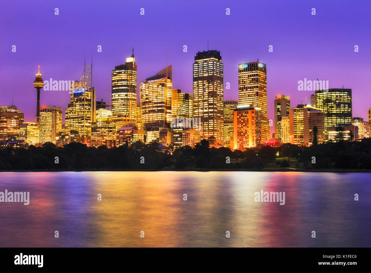 Sydney city CBD high-rise towers above Royal Botanic gardens at sunset ...