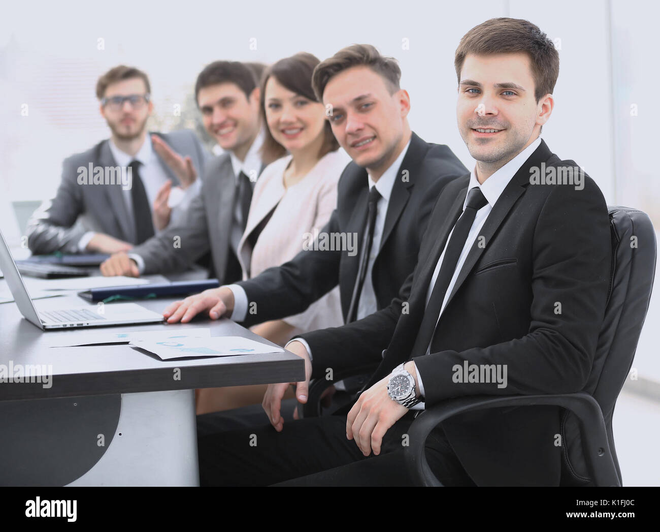 project Manager and professional business team sitting at Desk Stock ...