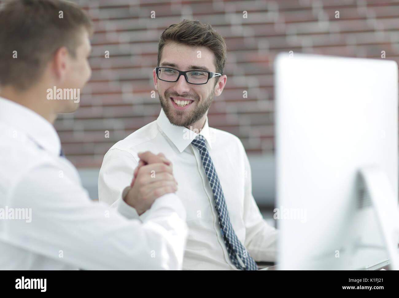 handshake Manager and customer in a modern office Stock Photo - Alamy