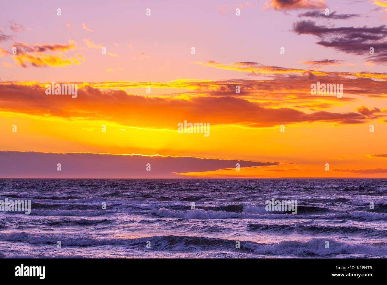 Beautiful sunset over rough ocean seas - nothing but sky and water ...