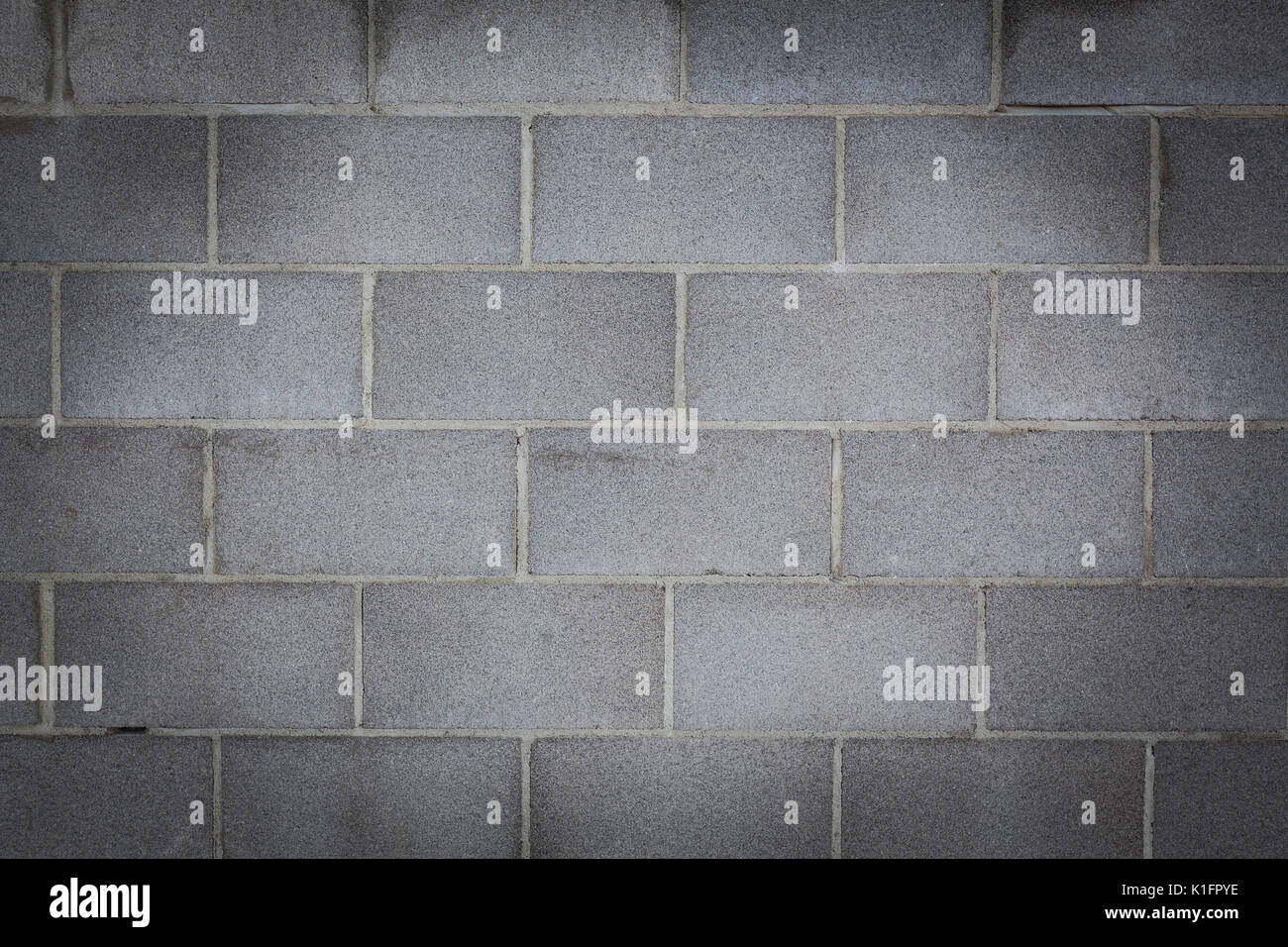 Clean and straight cinder block wall background texture with vignette ...