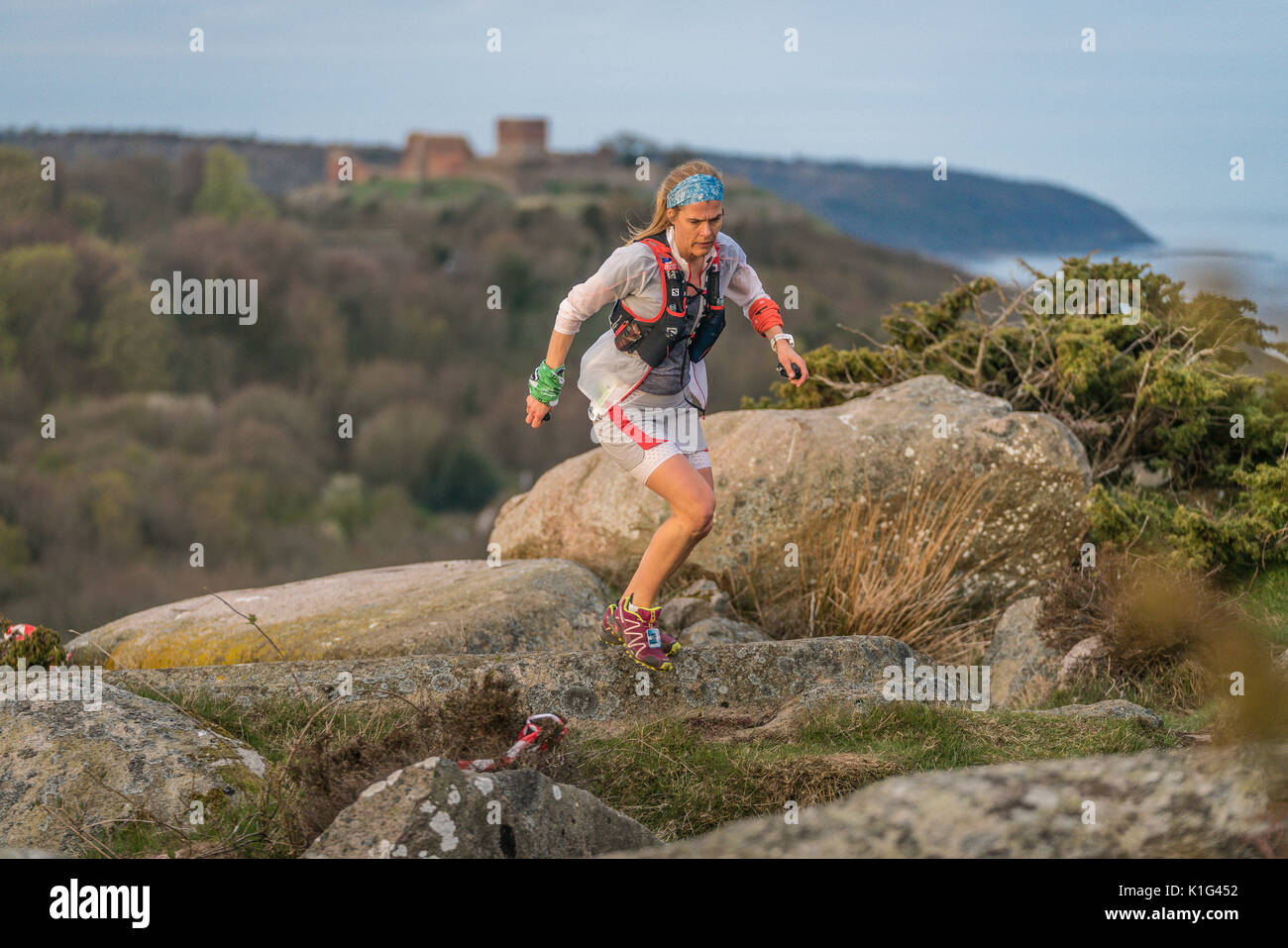 Woman/female trail runner on rocks Stock Photo - Alamy