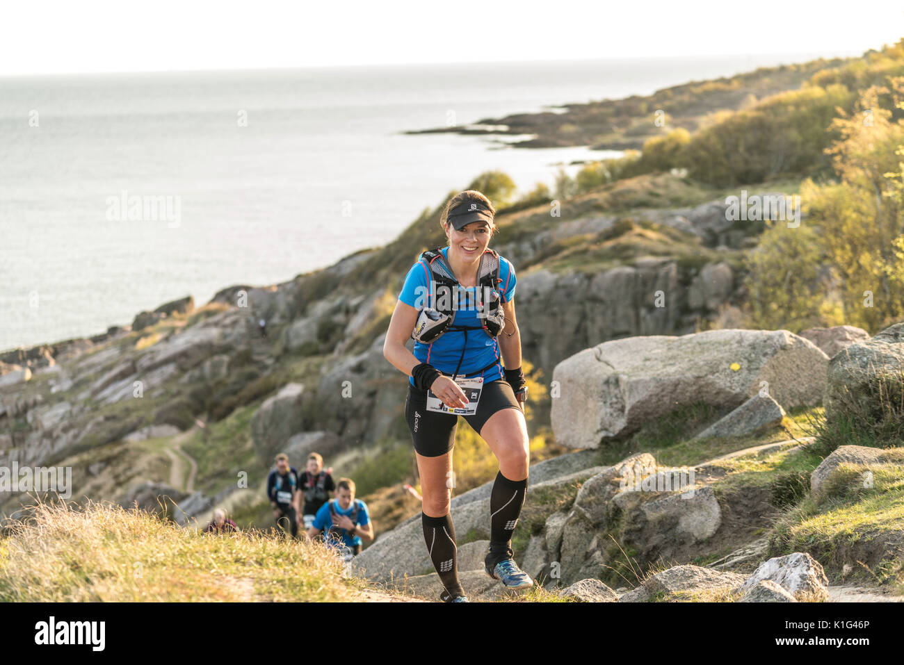 Woman/female trail runner on rocks Stock Photo - Alamy