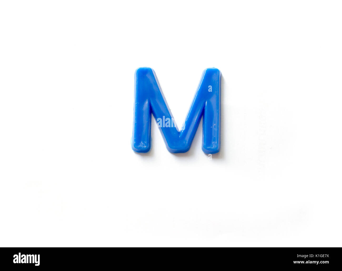Plastic letters M isolated white background Stock Photo - Alamy