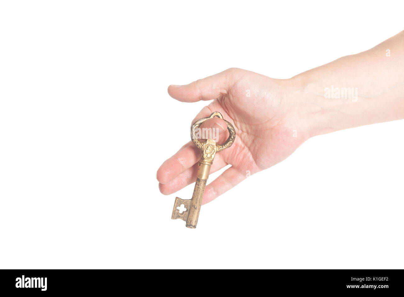 Man's hand with antique golden key isolated on white Stock Photo - Alamy