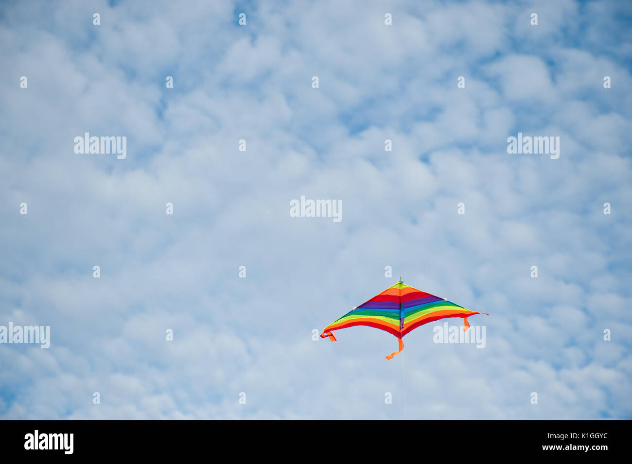 flying colorful kite on beautiful cloudy blue sky background Stock ...