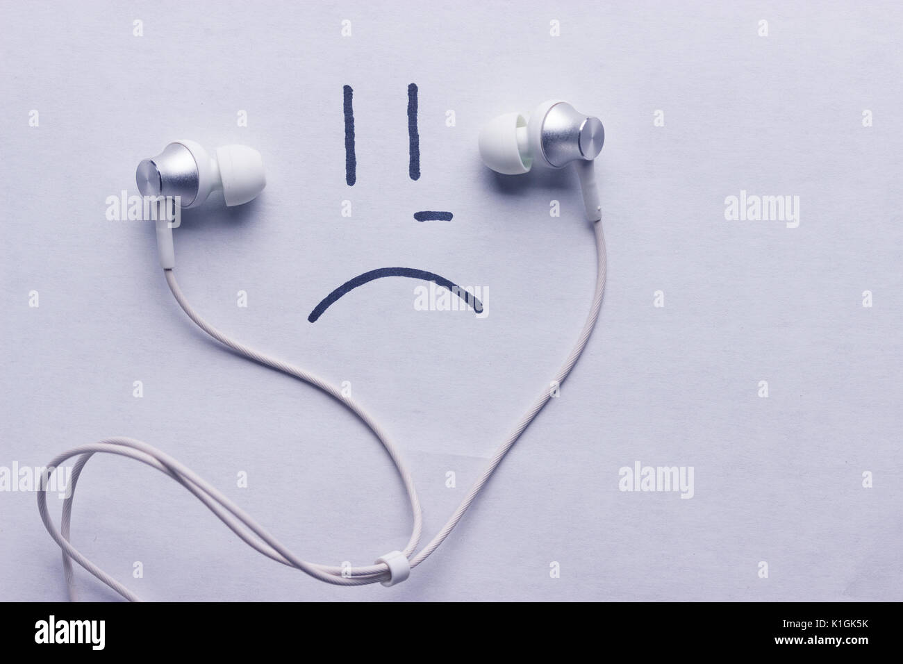 listen to sad music concept. headphones and sad smile Stock Photo - Alamy