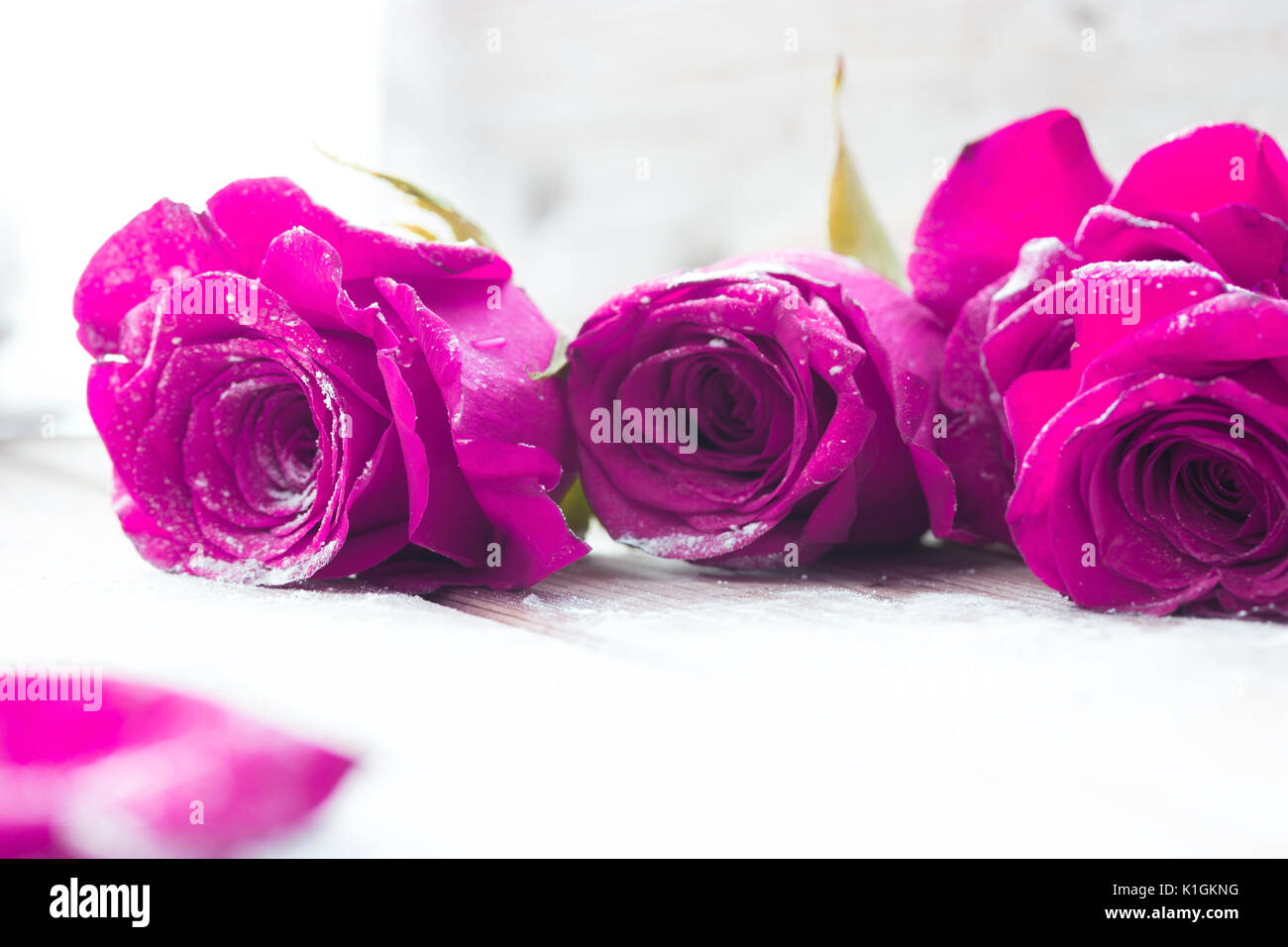 beautiful red color roses on wooden table Stock Photo - Alamy