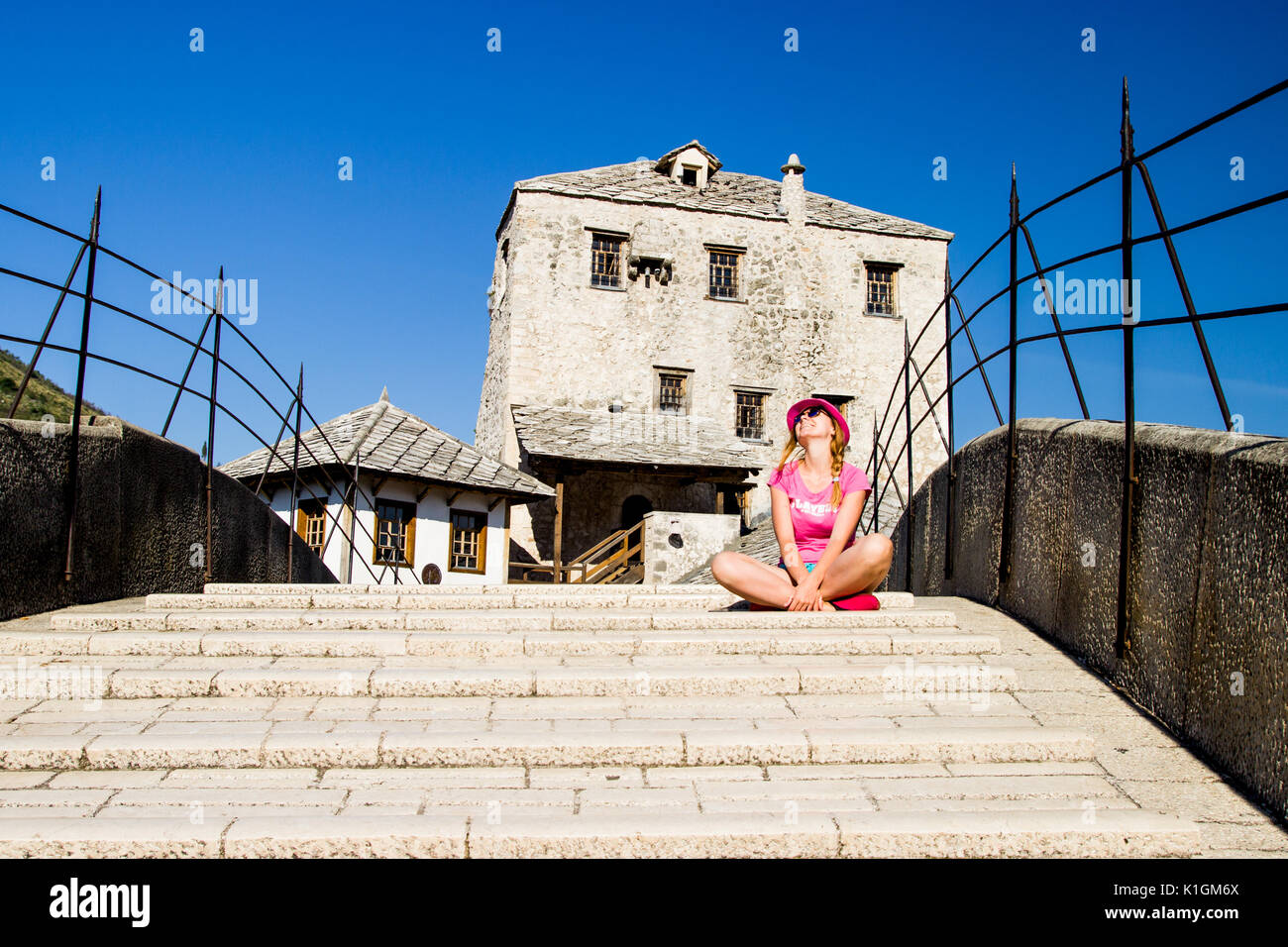 Pretty Girl in Red Hat Seats on a Bridge Mostar Bosnia Stock Photo - Alamy