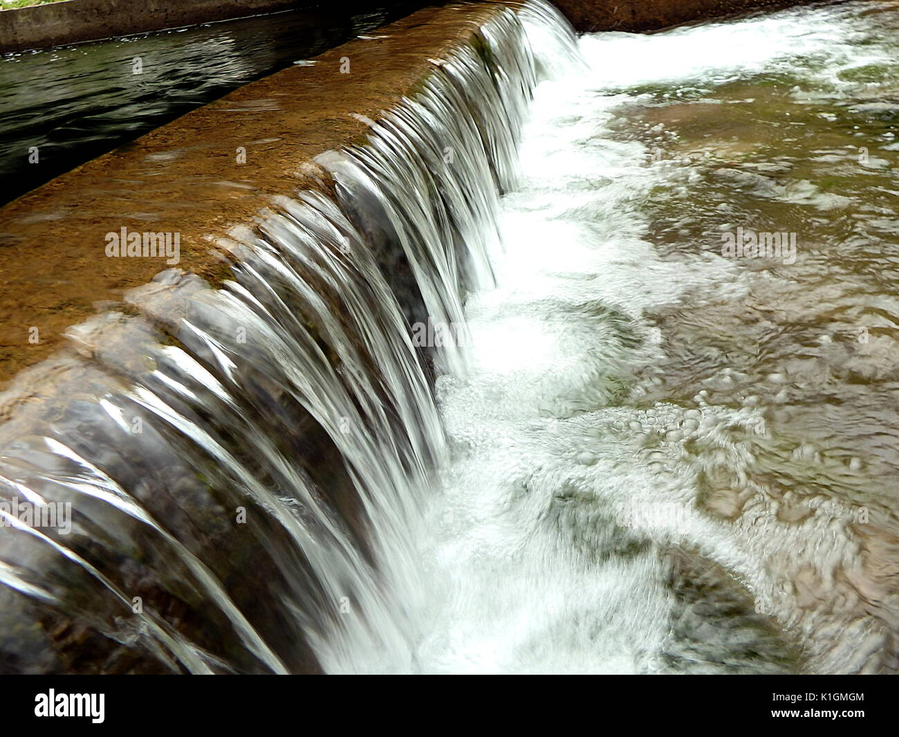 small waterfall, artificial cascade on the river Stock Photo - Alamy