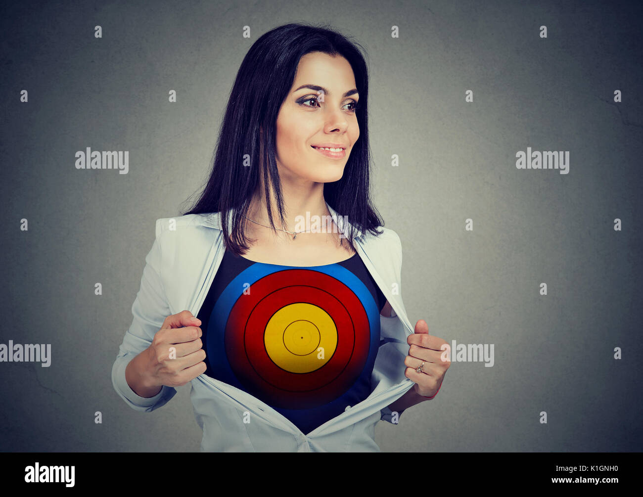 Determined business woman showing a target under her shirt Stock Photo ...