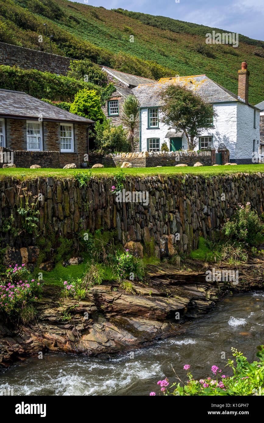 River Valency and river bank supported by a wall of slate stones ...