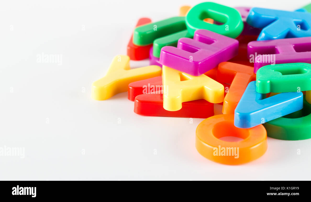 Colorful plastic alphabet letters on white background Stock Photo - Alamy