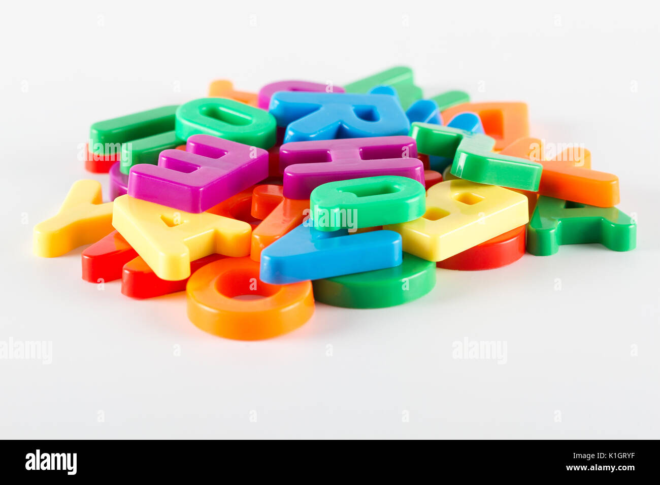 Colorful plastic alphabet letters on white background Stock Photo - Alamy