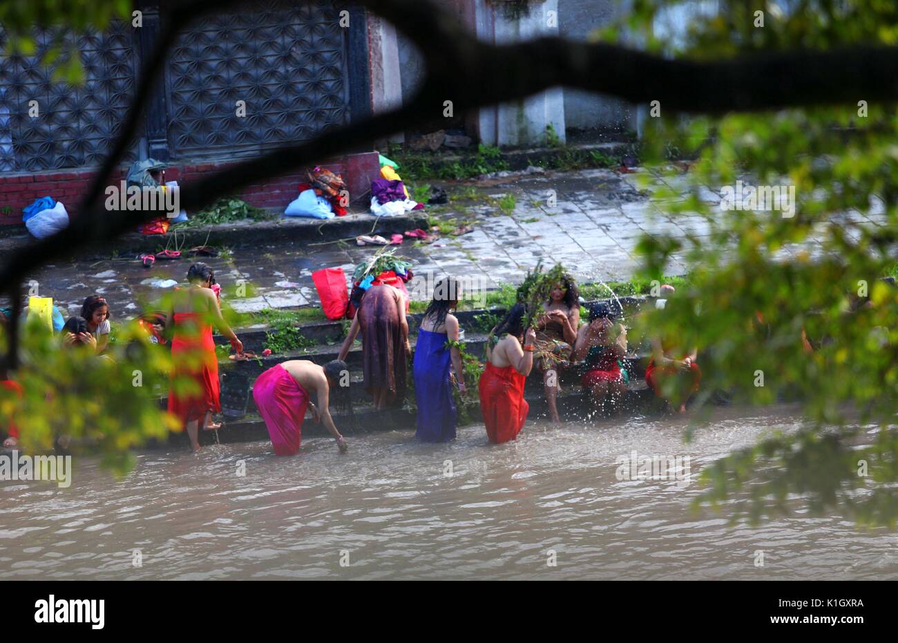 Kathmandu, Nepal. 26th Aug, 2017. Hindu women take bath to clean ...