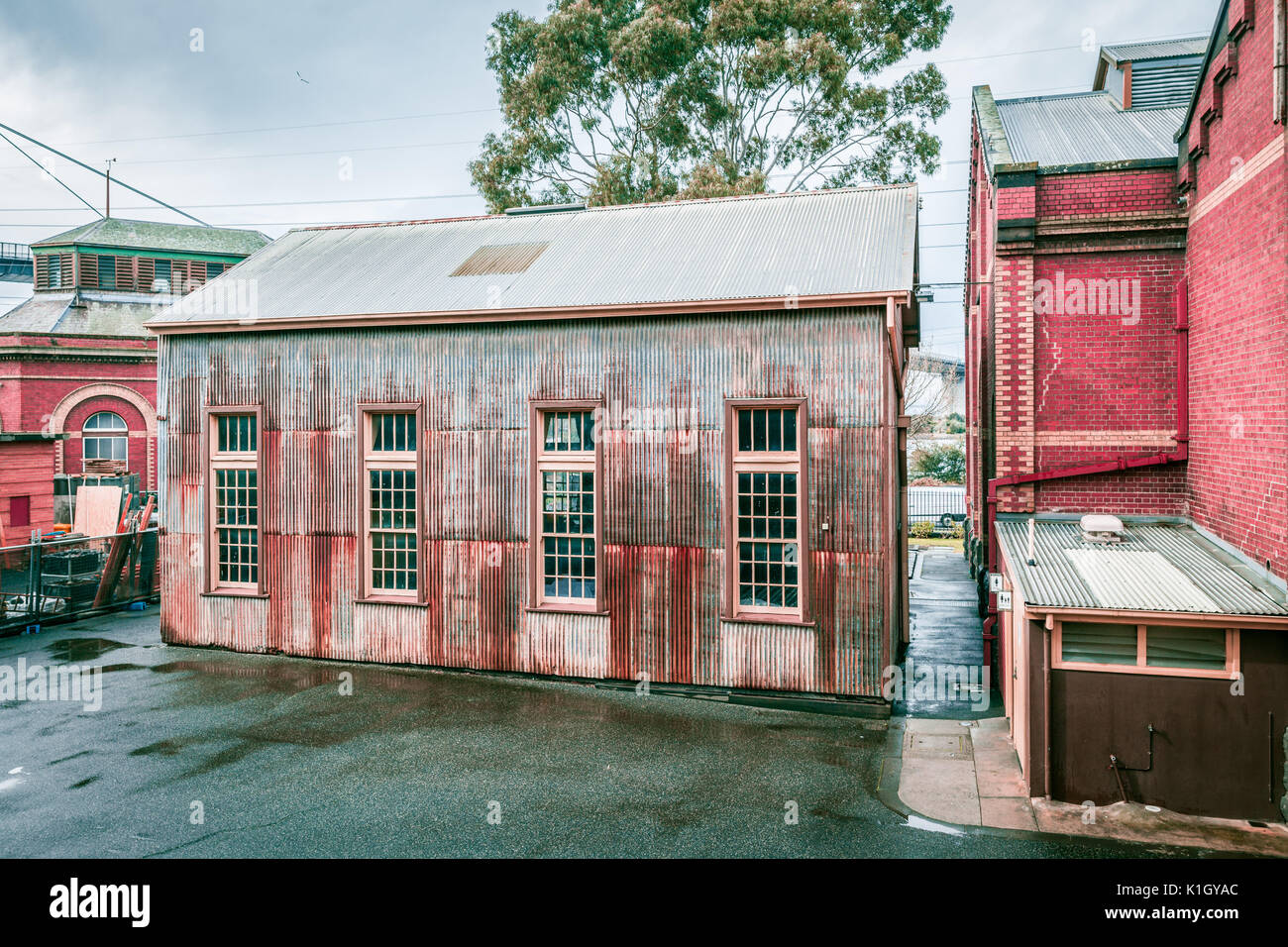 Old rusty metal shed with tall windows Stock Photo - Alamy