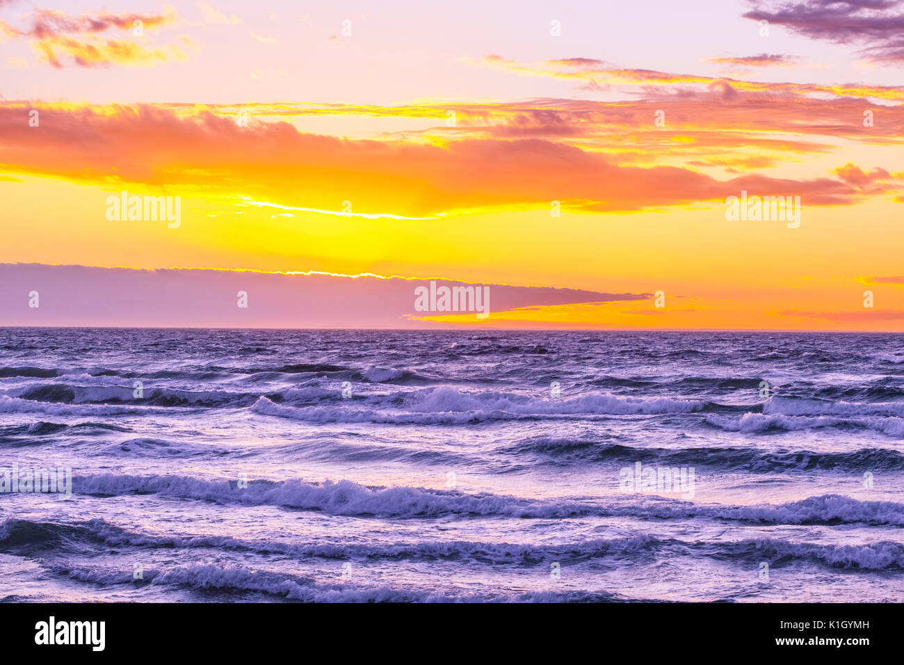 Beautiful sunset over rough ocean seas - nothing but sky and water ...