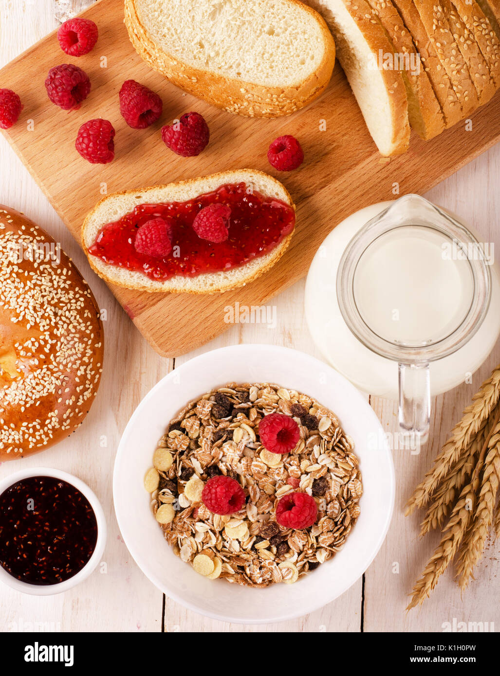 Healthy breakfast. Cereal breakfast with muesli, milk, jam, bread and ...