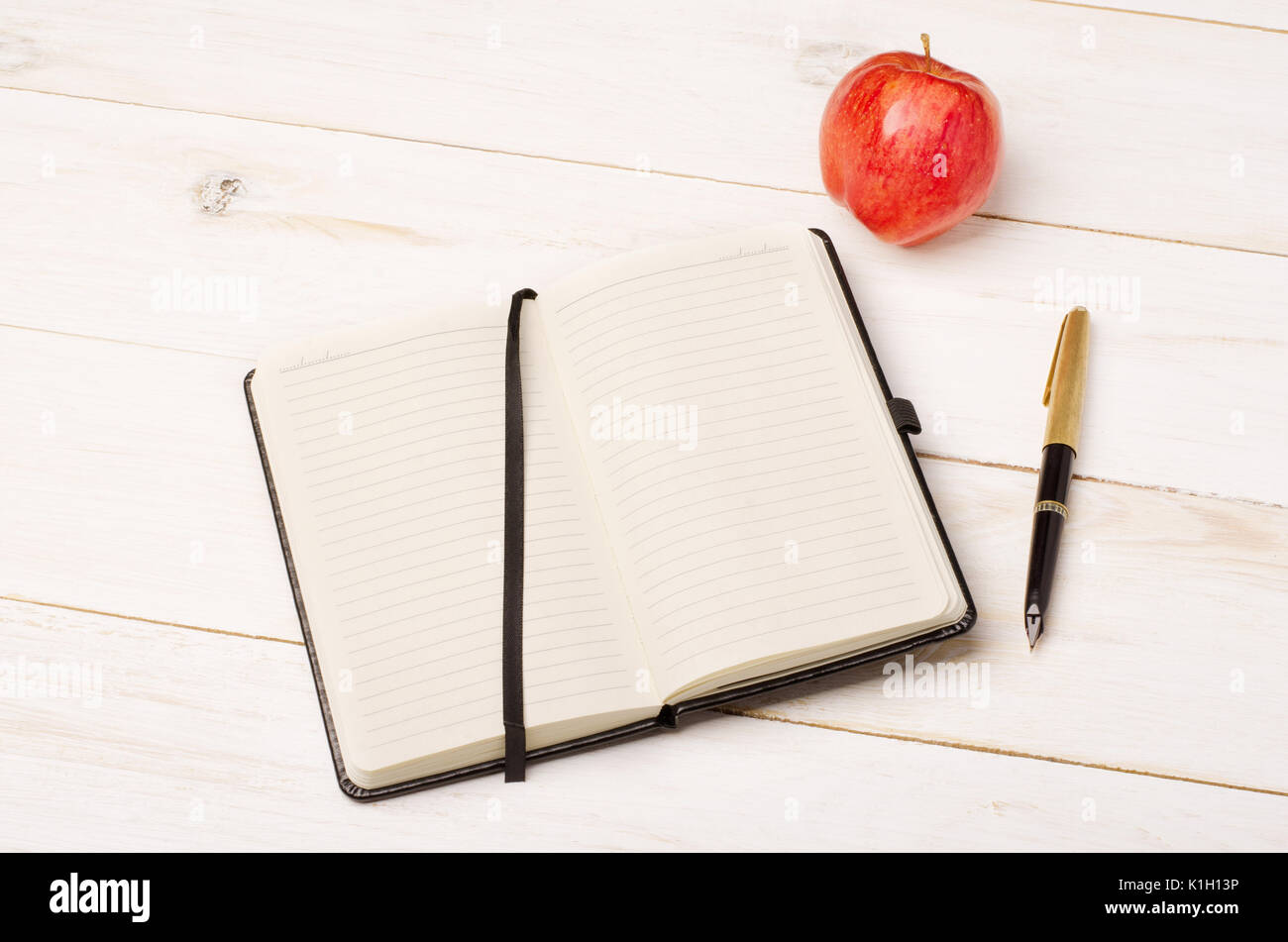 Diary, apple and pen on rustic wooden table Stock Photo - Alamy