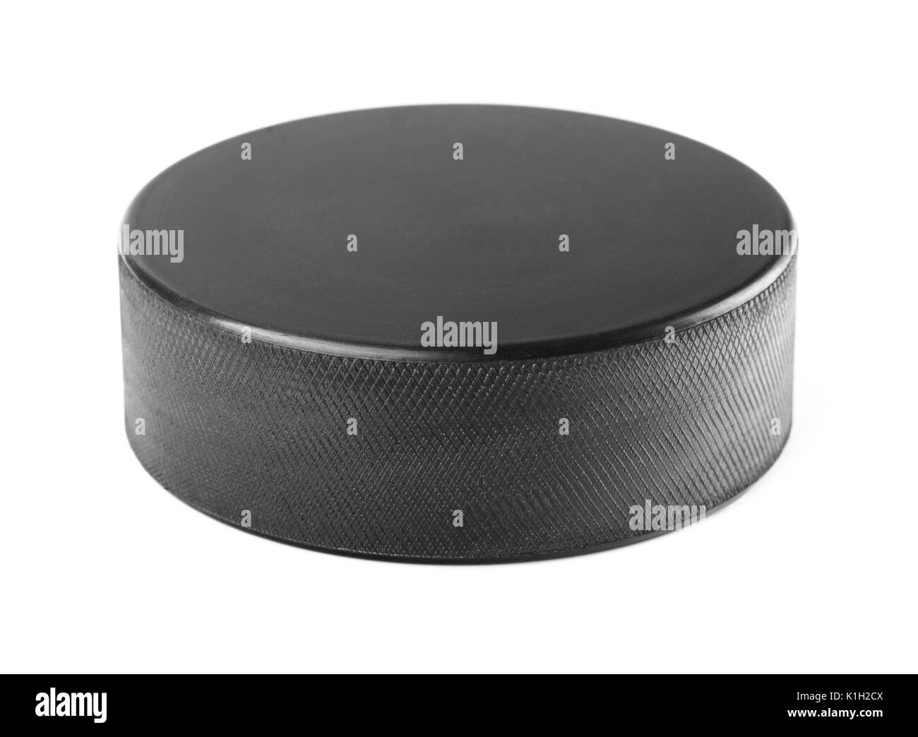 Black rubber hockey puck isolated on white background Stock Photo - Alamy
