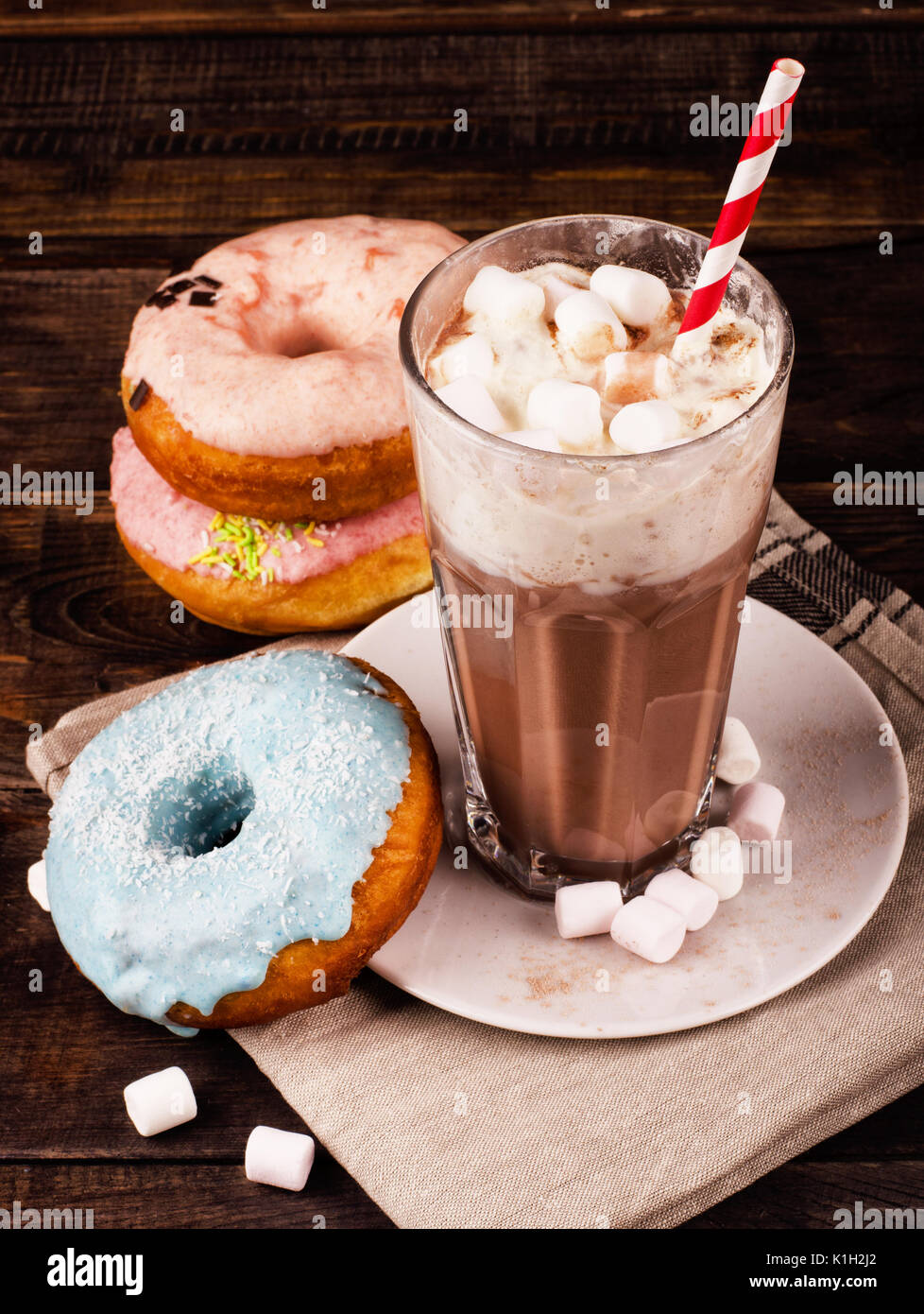 Milkshake and donuts on a dark wooden background Stock Photo - Alamy