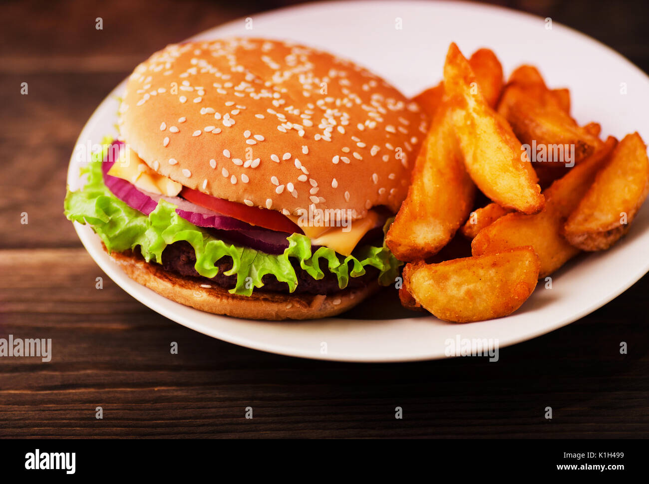 Big delicious burger with beef, tomato, cheese, onion and lettuce with ...