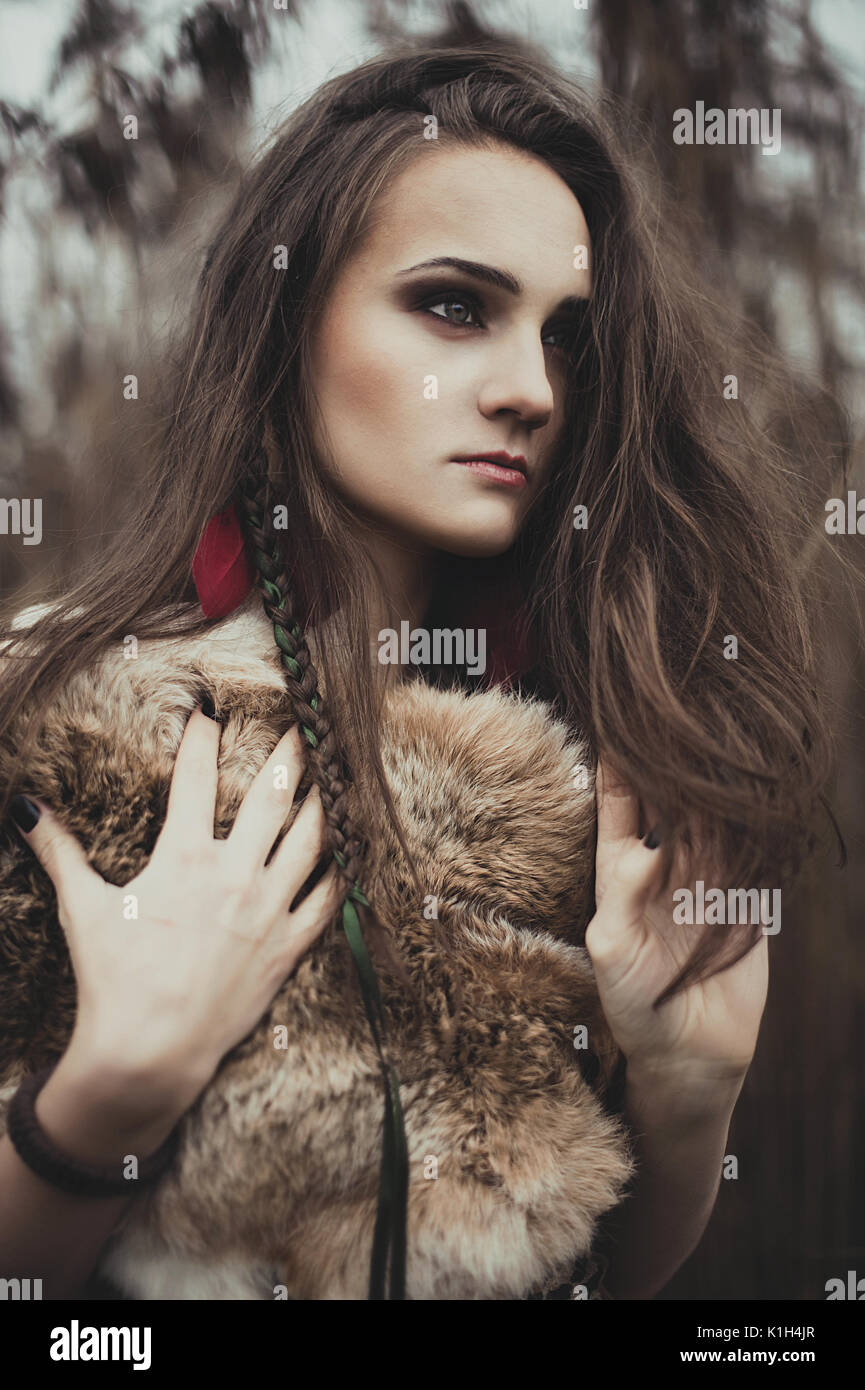 Artistic portrait of young beautiful woman in Indian style with fur on ...