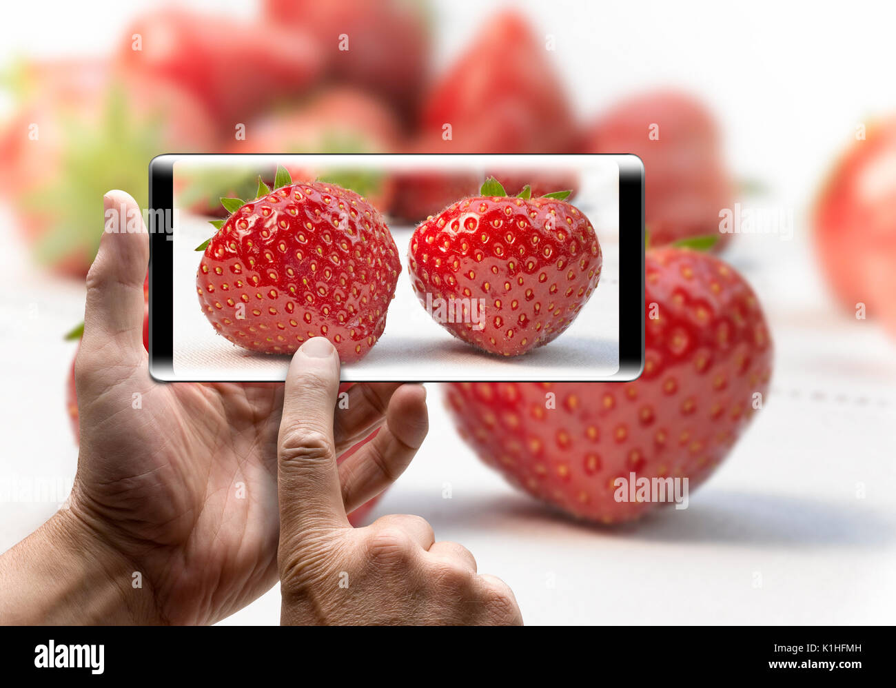 Two hands holding a mobile Smartphone and take a picture of fresh ...