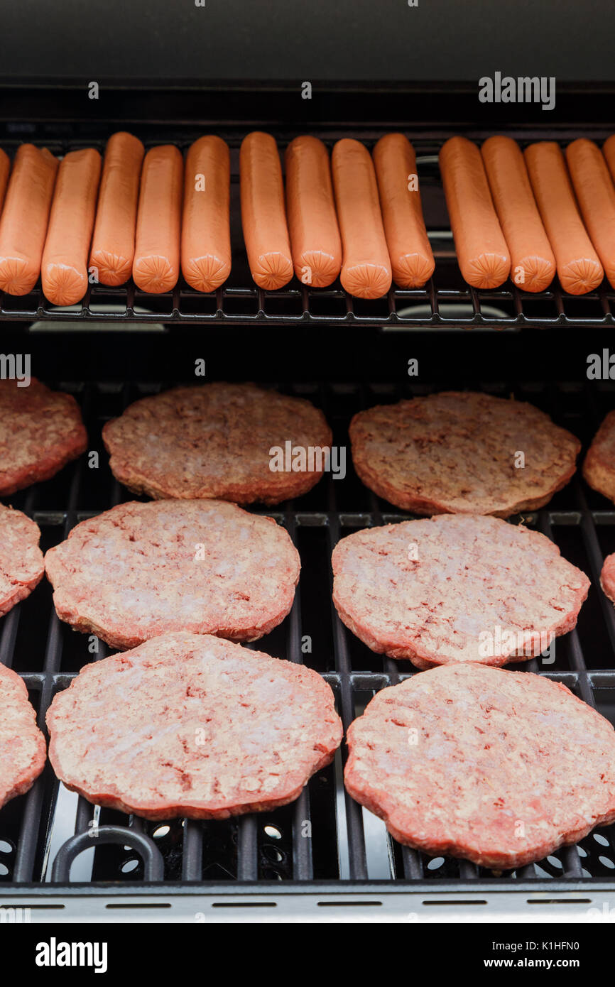 Hamburger Patties and Hot Dogs Cooking on a New Gas Grill Stock Photo ...