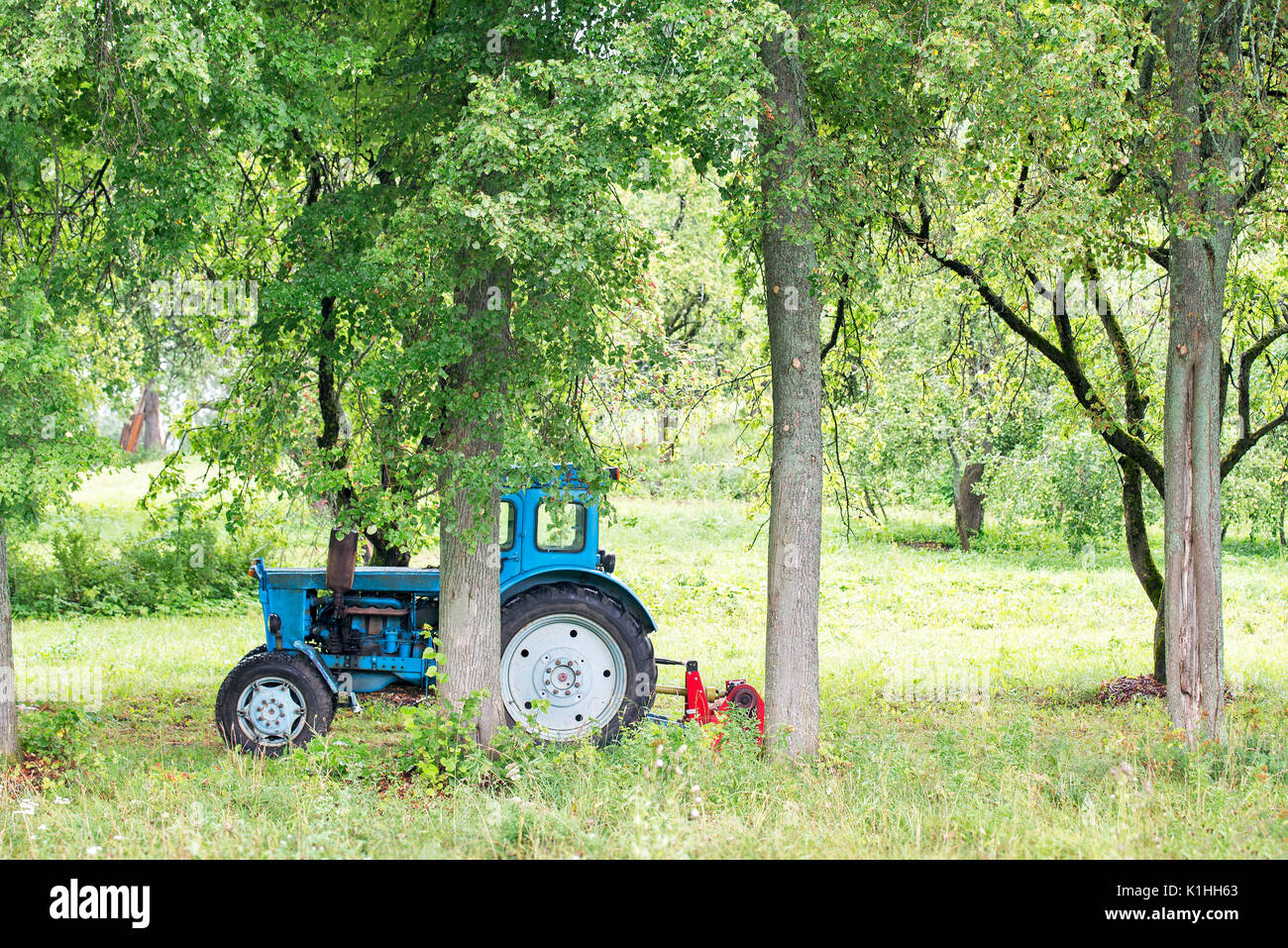 Old Russian tractor in the garden Stock Photo - Alamy