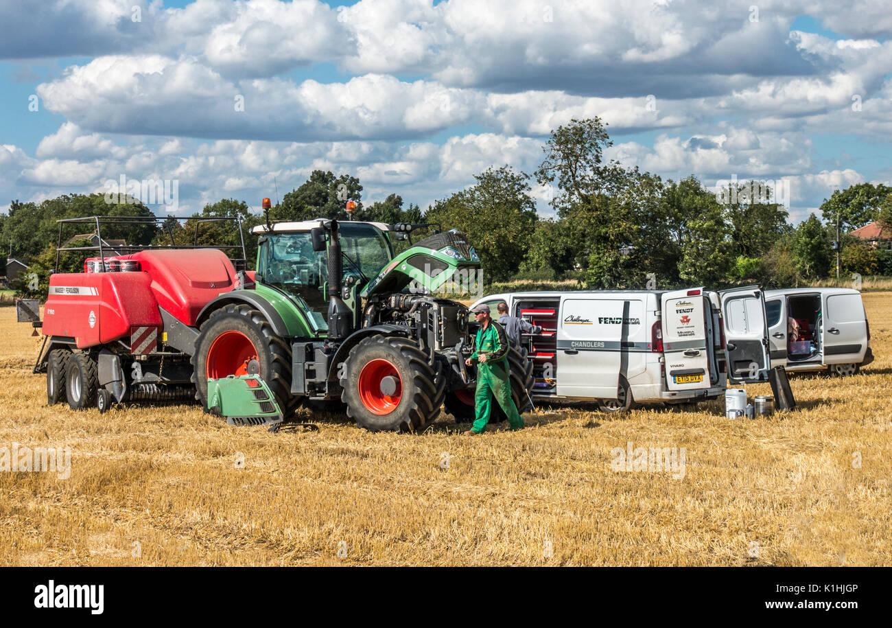 Mechanics on callout to repair a broken down tractor with bonnet up, in ...