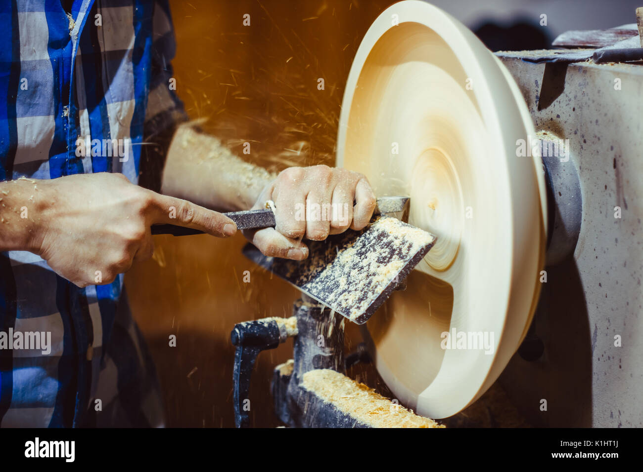 man turning a wooden plate on a lathe Stock Photo - Alamy