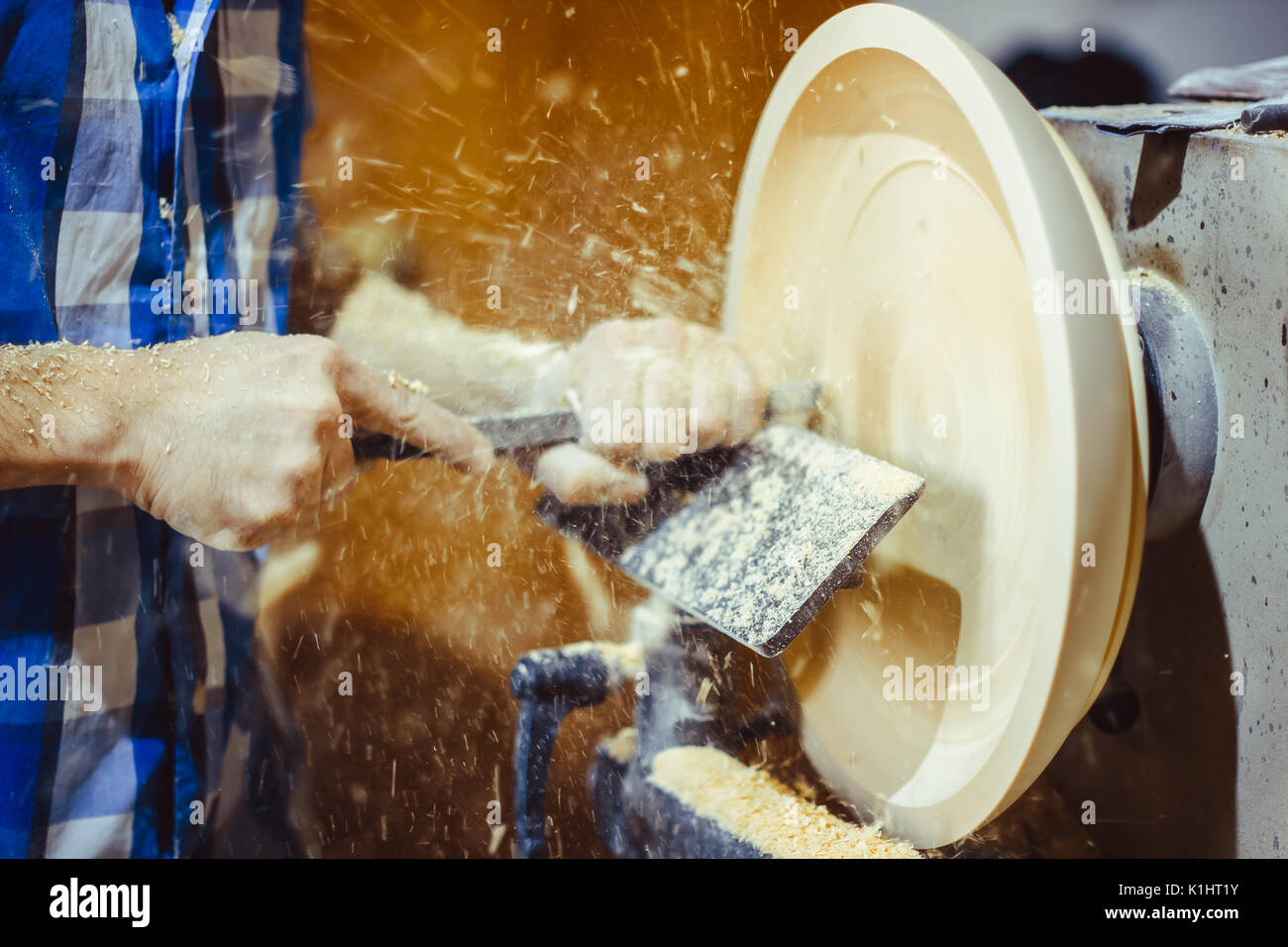 man turning a wooden plate on a lathe Stock Photo - Alamy