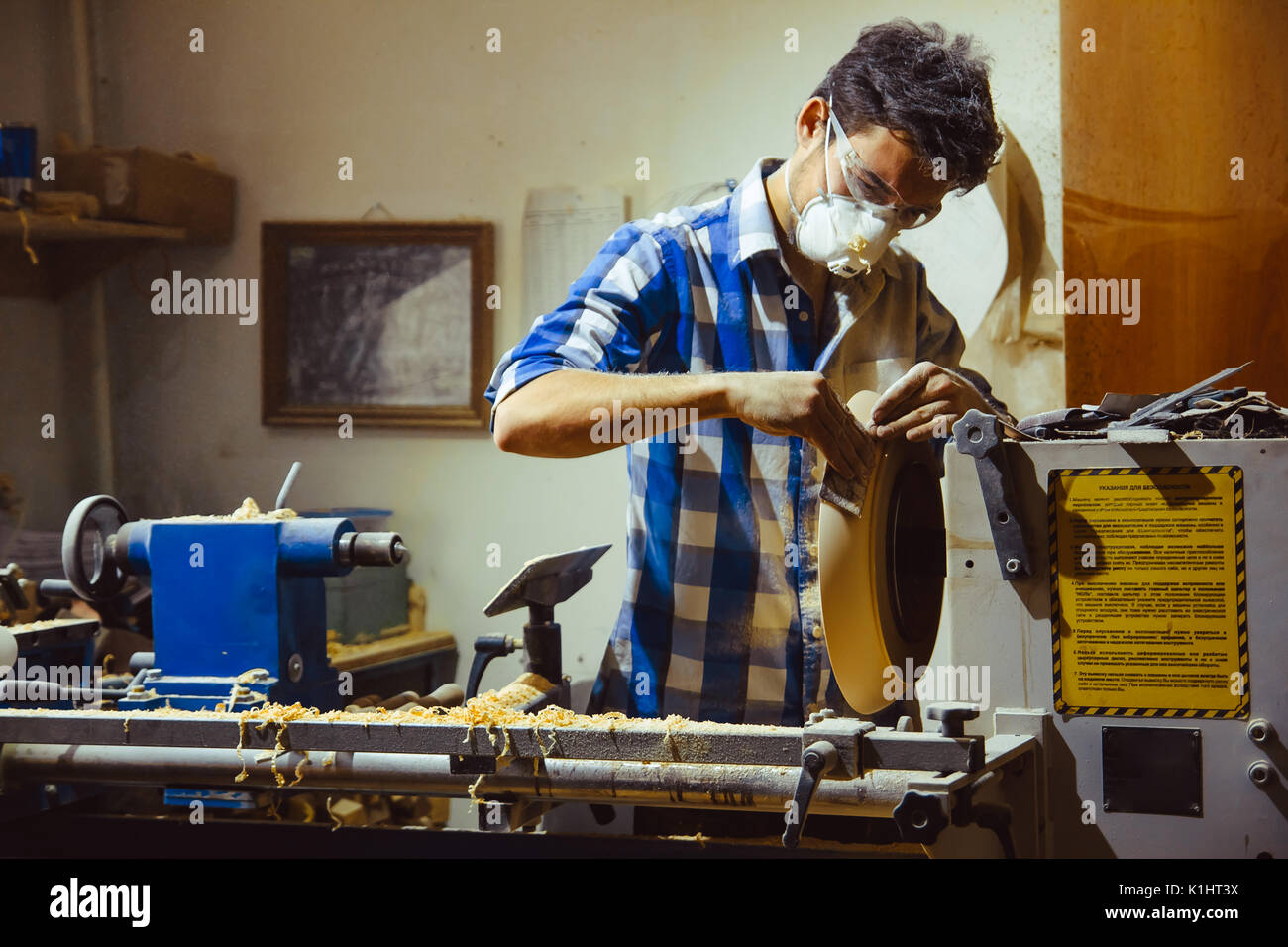 man turning a wooden plate on a lathe Stock Photo - Alamy