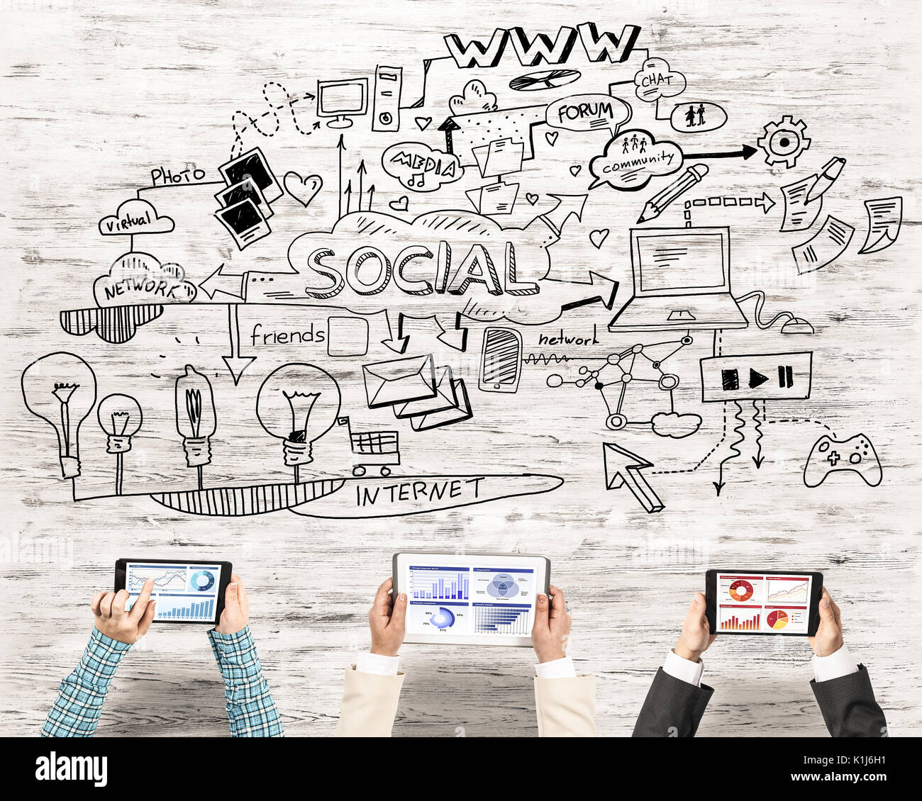 Group of three people with devices in hands working together as symbol ...