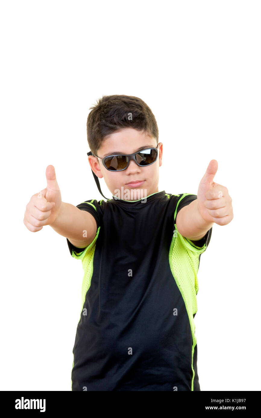 Little boy is making OK sign with a confident pose in front of a white ...