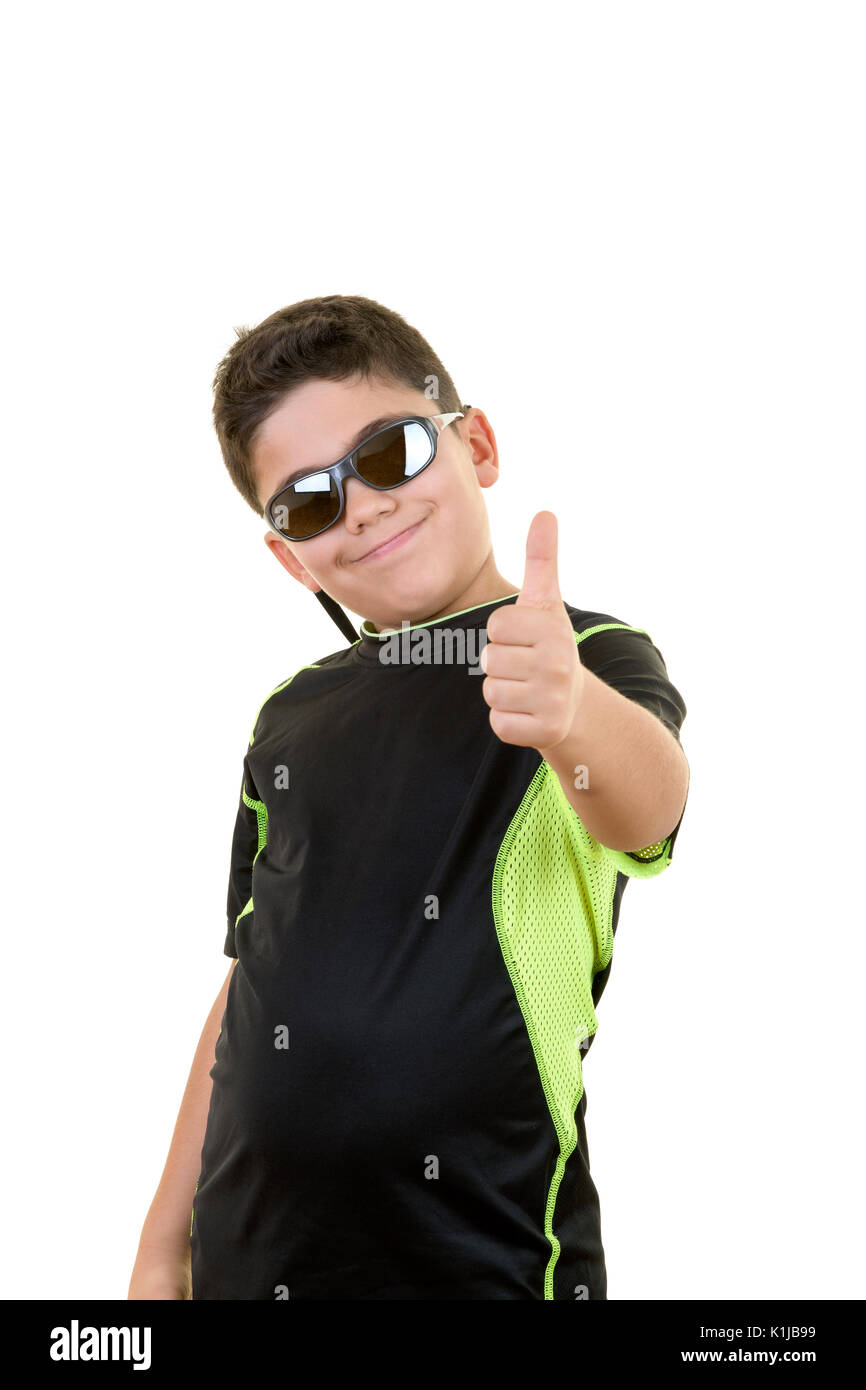 Little boy is making OK sign with a confident pose in front of a white ...