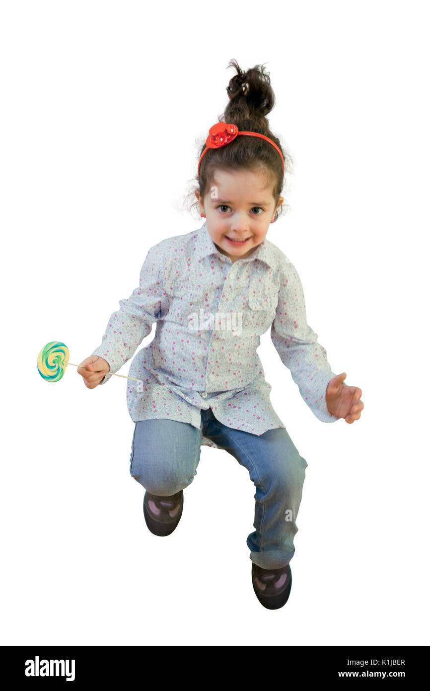 Little pretty girl is jumping fast with her colorful candy while ...