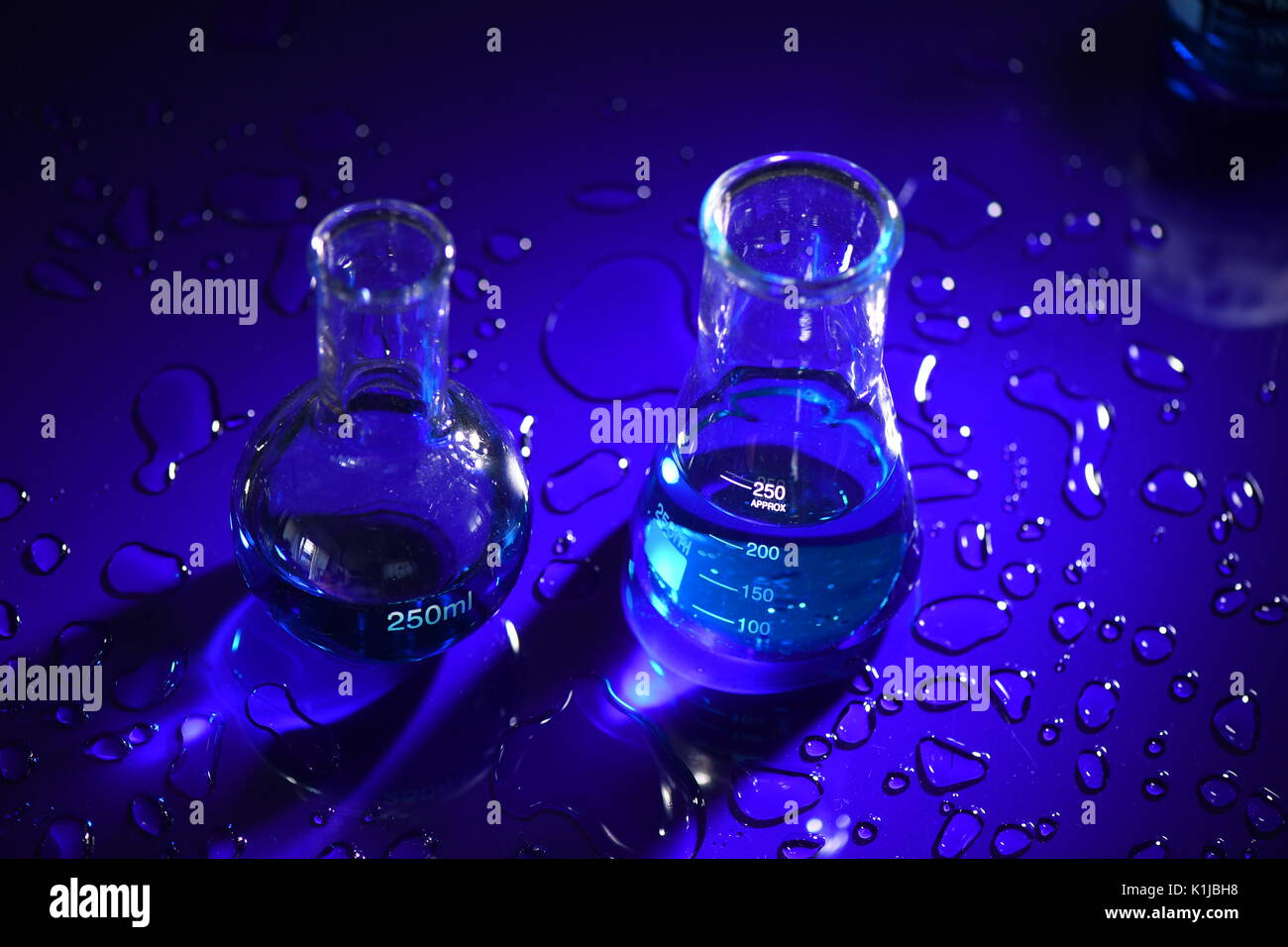 Graduated Conical Science Beakers on blue acrylic Stock Photo - Alamy