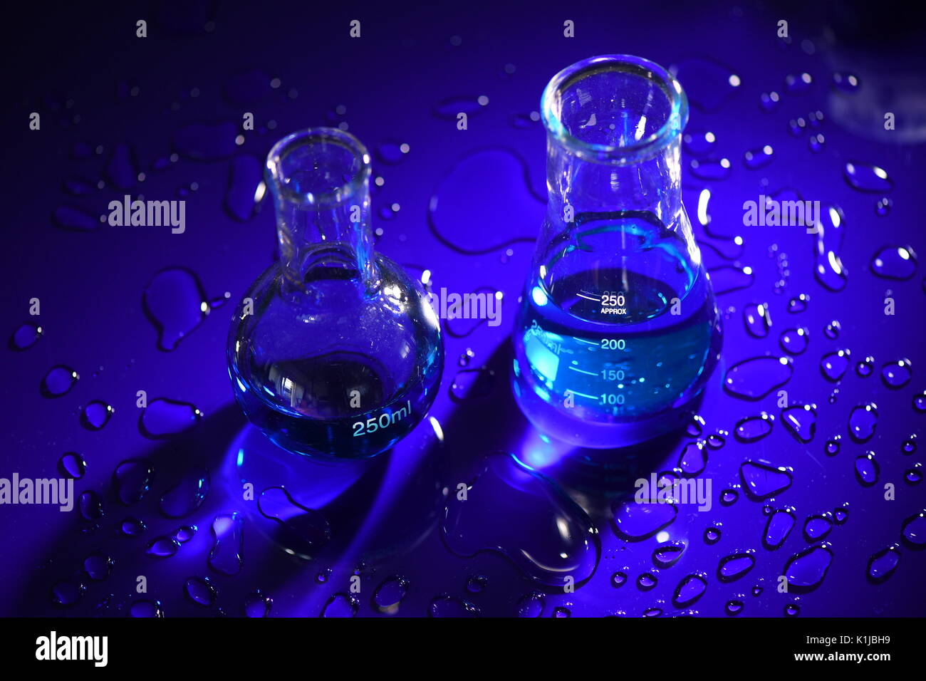 Graduated Conical Science Beakers on blue acrylic Stock Photo - Alamy