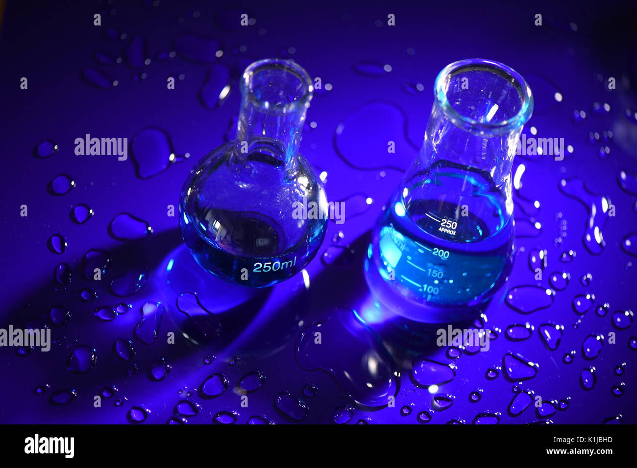 Graduated Conical Science Beakers on blue acrylic Stock Photo - Alamy