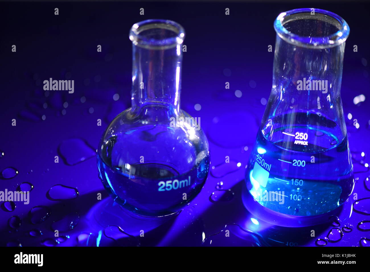 Graduated Conical Science Beakers on blue acrylic Stock Photo - Alamy